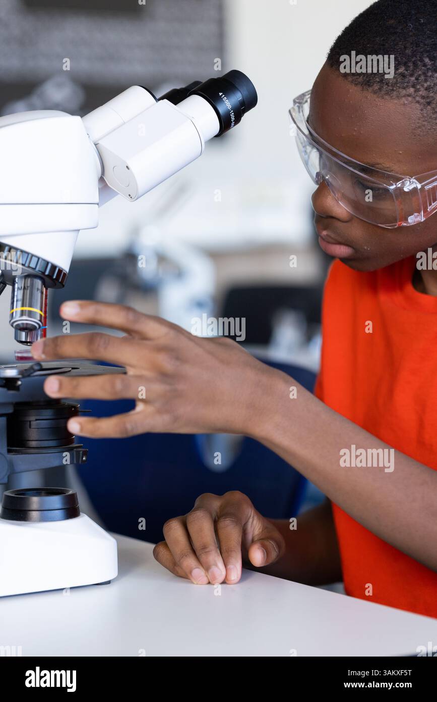 Using microscope student conducting hi-res stock photography and images ...