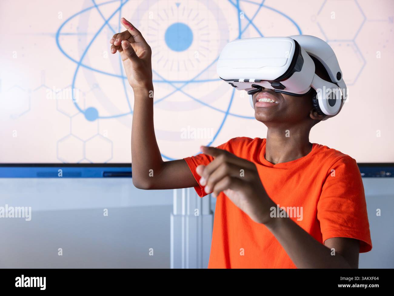 Using VR headset, student in school engaging with virtual reality ...
