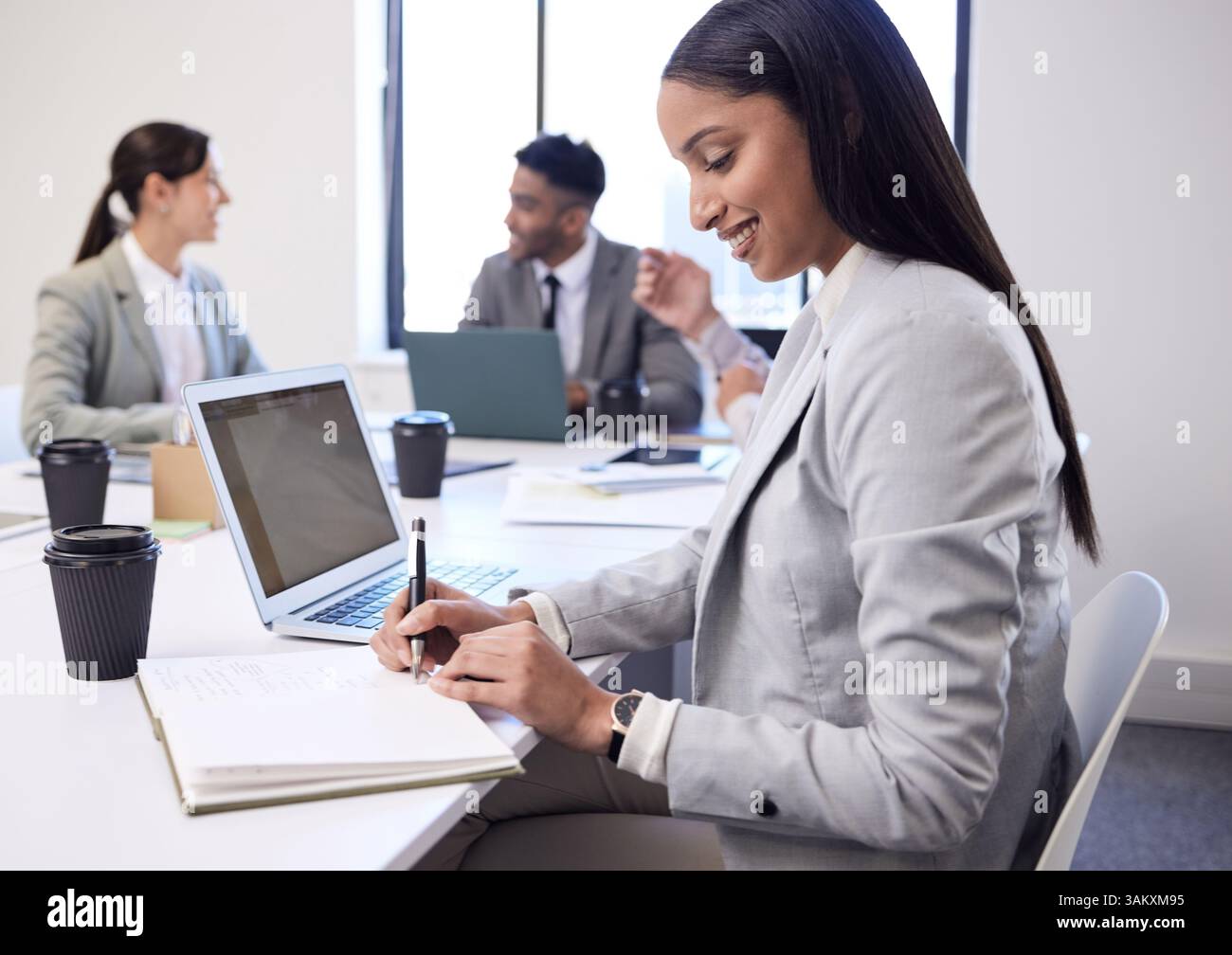 Happy, business woman and writing with book in meeting for ...