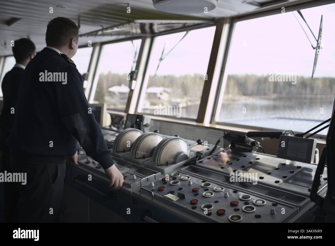 Navigation officer driving cruise liner on the river Stock Photo - Alamy