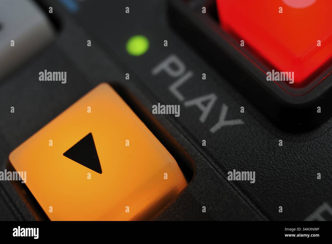 Macro shot of the yellow color Play button and a piece of red Record ...