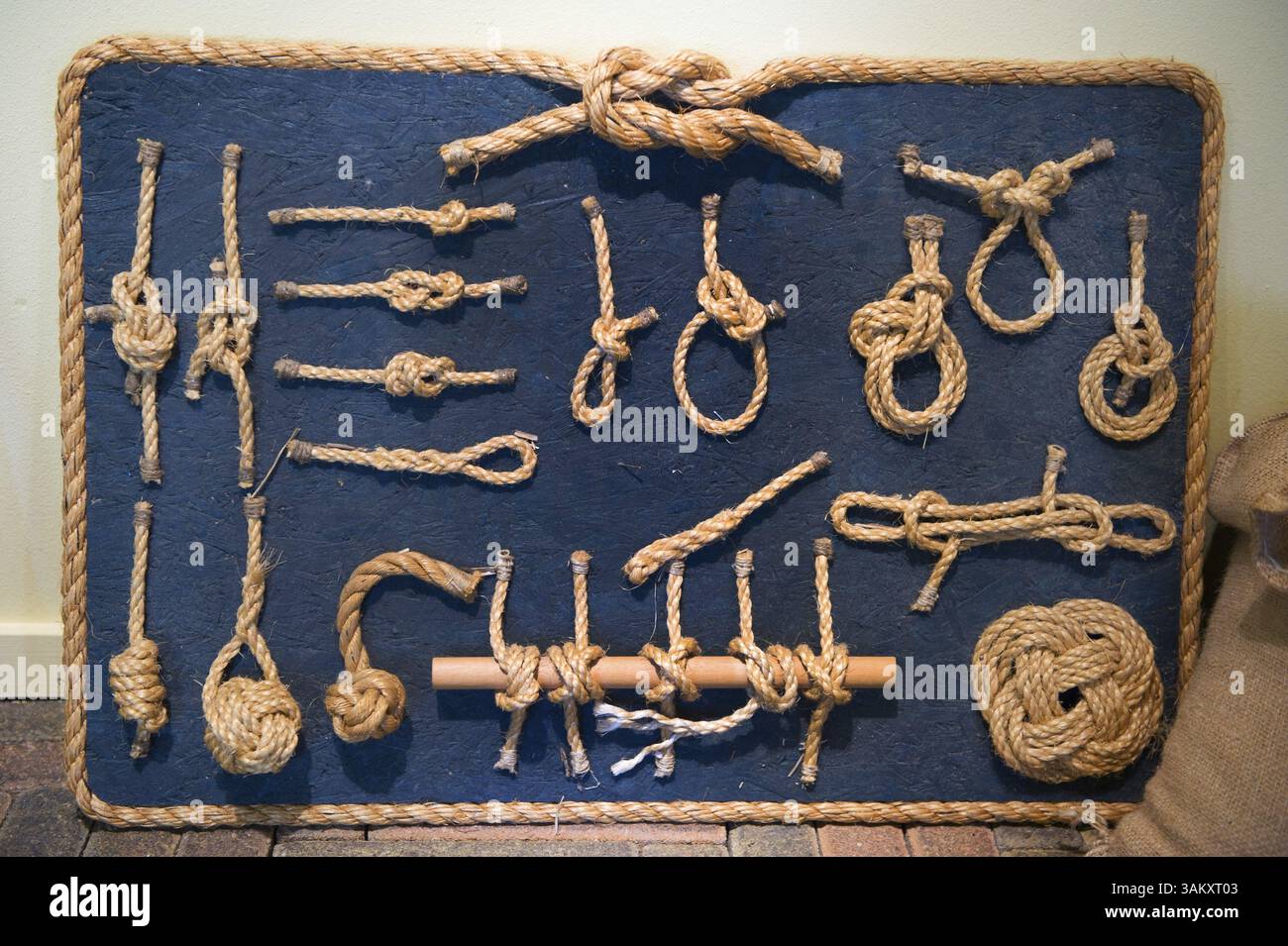 Many ship knots in natural rope on blue board Stock Photo - Alamy