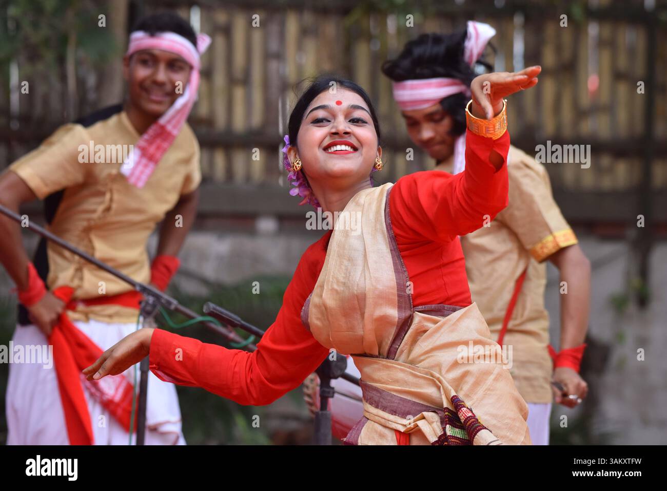 Assam. 12th Apr, 2025. A woman in traditional dress performs folk dance during pre-celebrations ...
