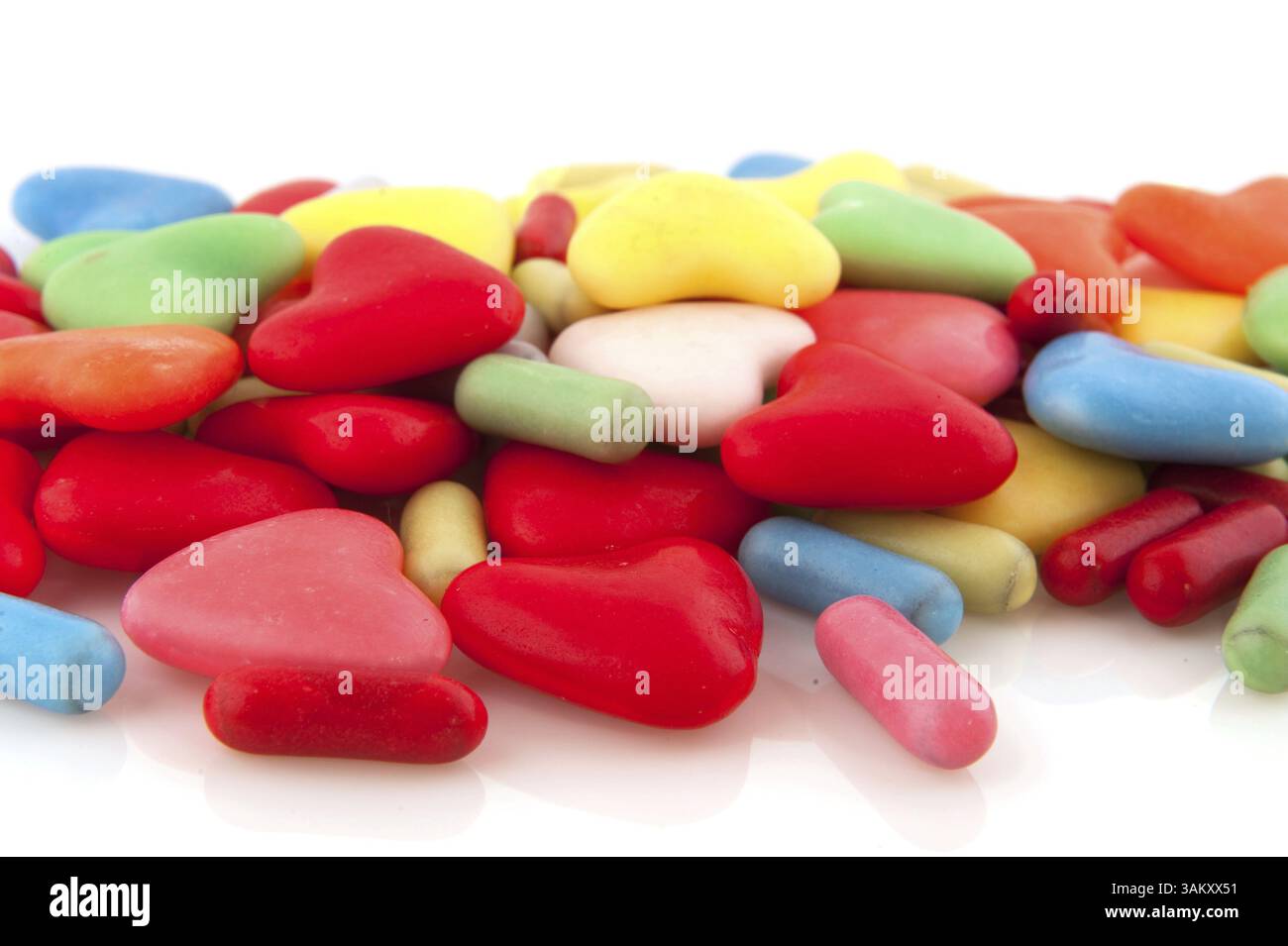 Many colorful candy hearts isolated over white Stock Photo - Alamy