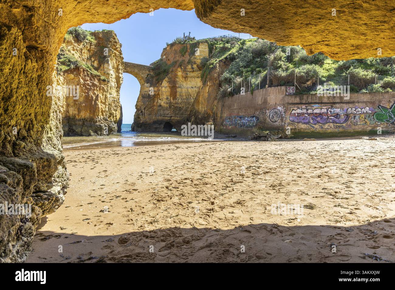Yellow rocks and cliffs on a sandy beach. A bay by the sea, over which ...