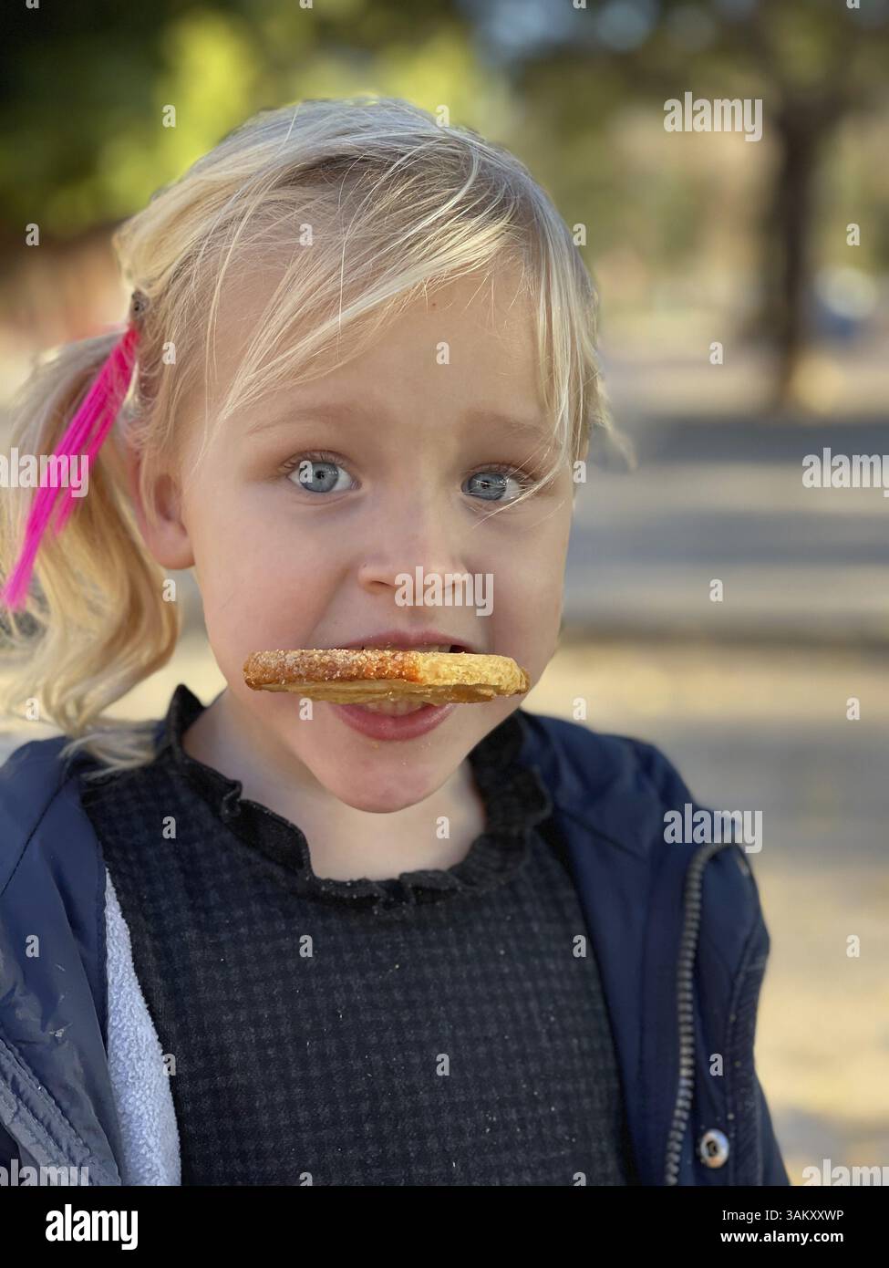 Close-up portrait of a lovely fair-haired girl looking funny with a ...
