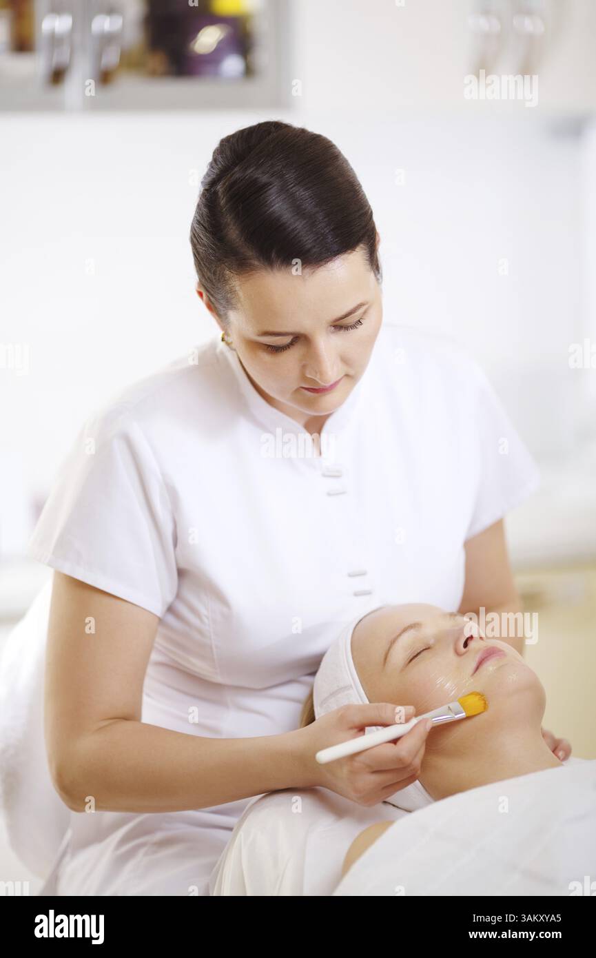 Professional cosmetologist peeling off facial hi-res stock photography ...