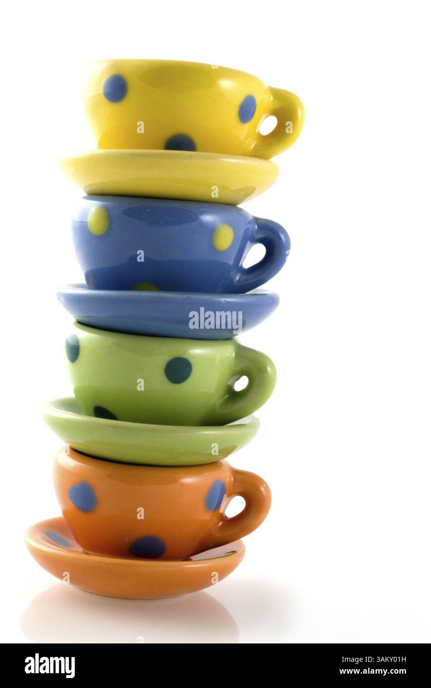 Pile of colored cup and saucers with dots Stock Photo - Alamy