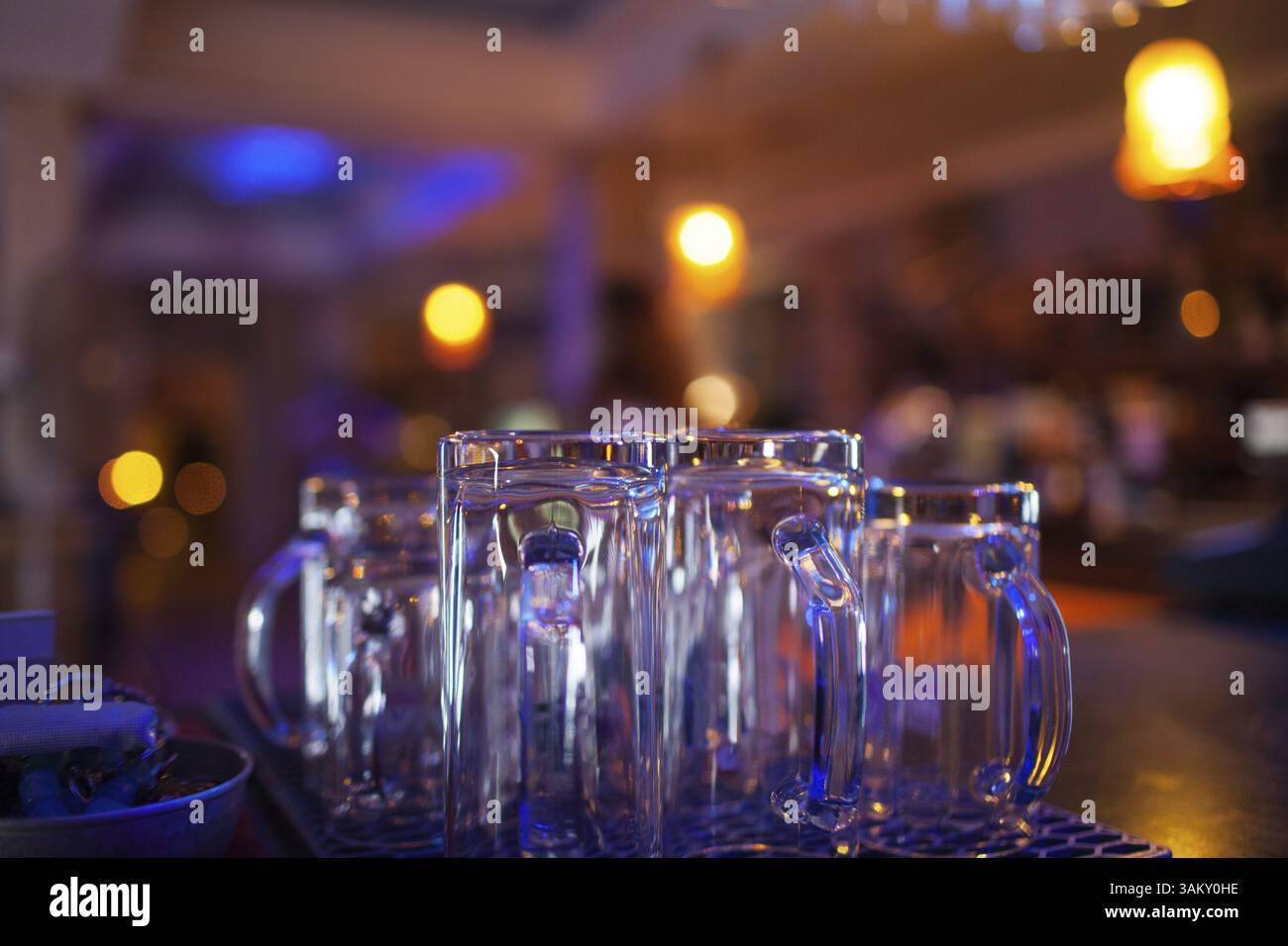 Clean glassware on the counter of a nightclub ready to serve customers ...