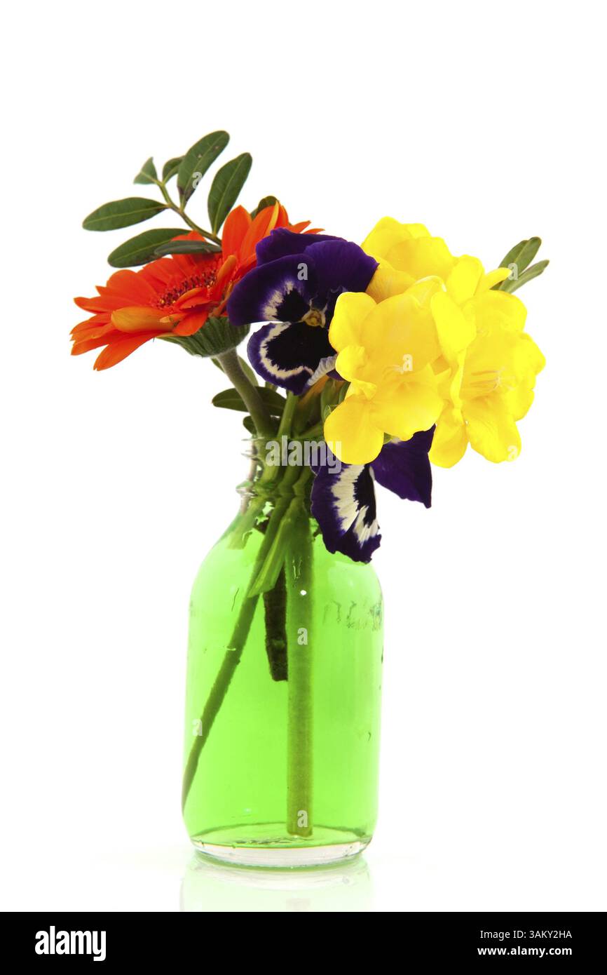 Bouquet colorful flowers in green glass bottle Stock Photo - Alamy