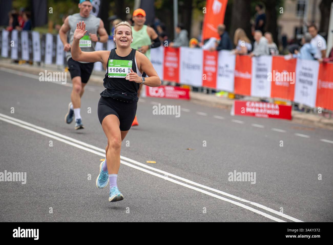 A young woman takes part in the 2025 Canberra Marathon. Runners ...