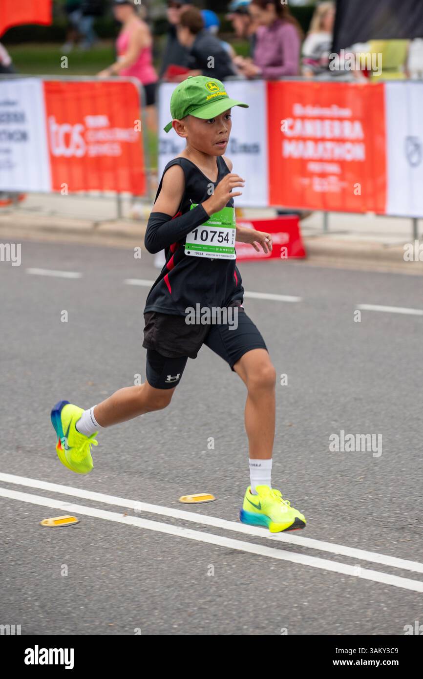 A young boy takes part in the 2025 Canberra Marathon. Runners ...