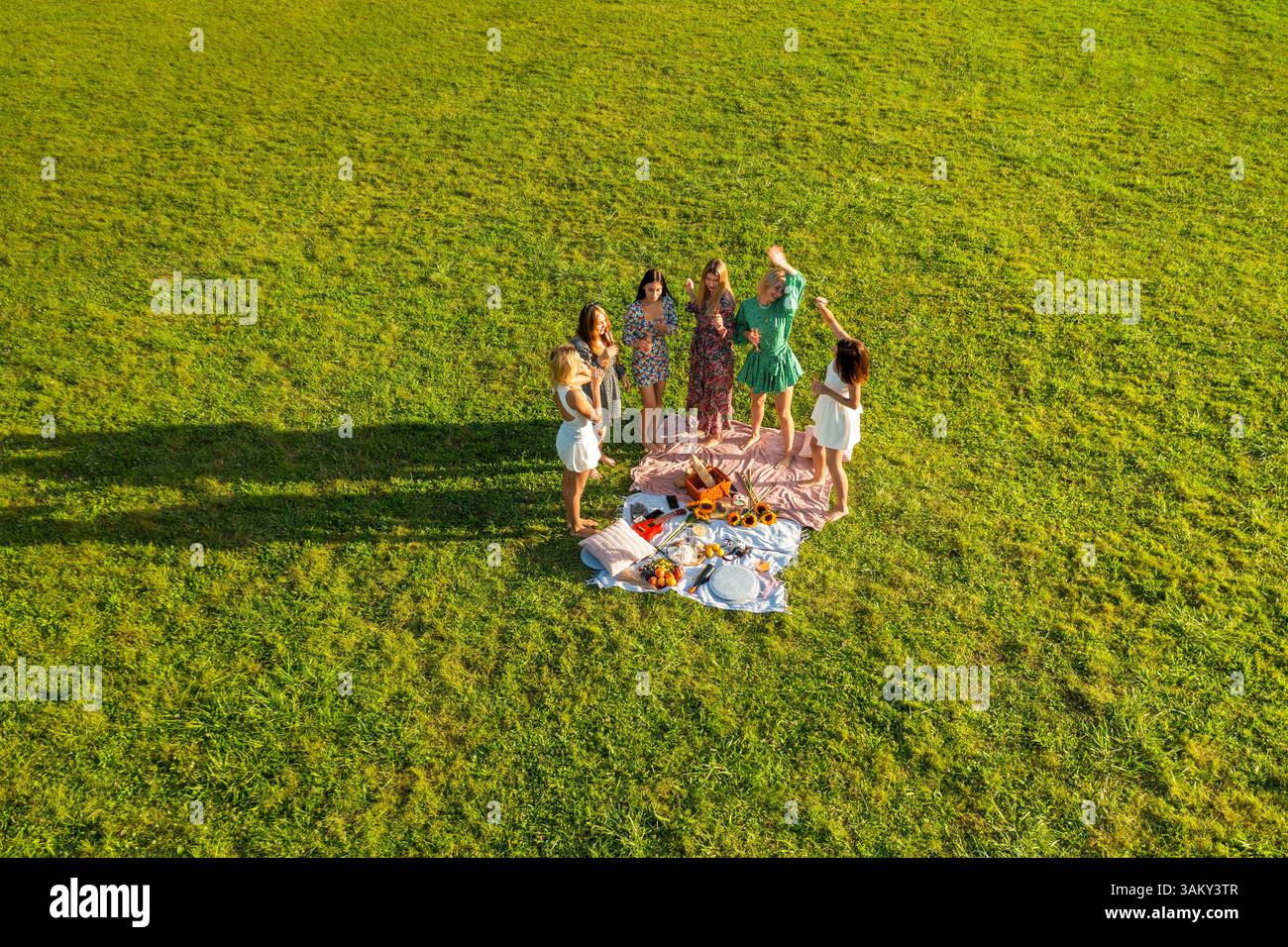 Drone aerial view with a group of women dancing and having fun at a ...
