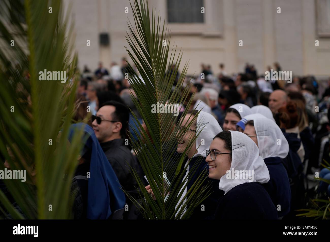 Palm branches are distributed ahead of the mass on Palm Sunday in St ...