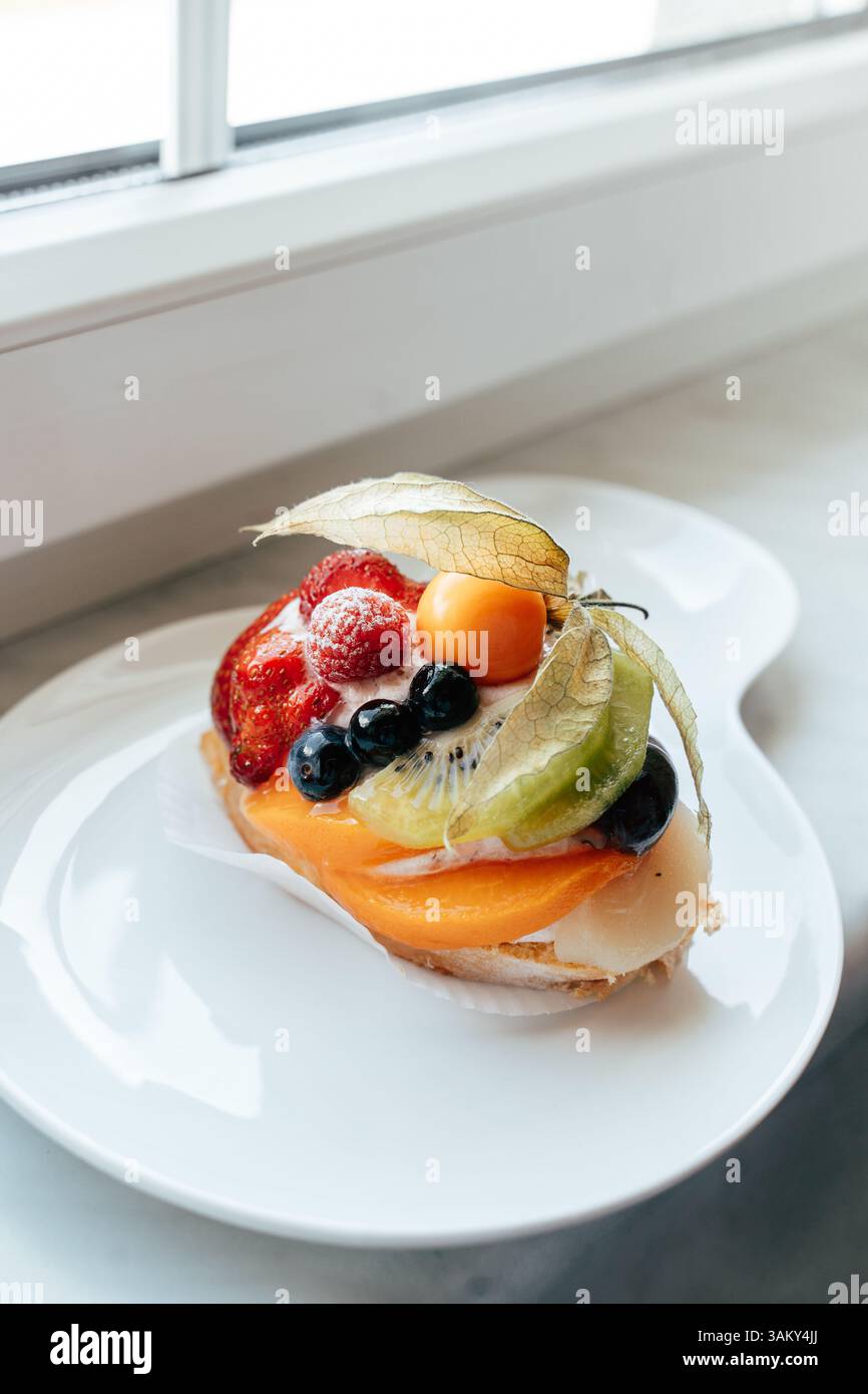 A beautifully arranged dessert displaying layers of fresh fruits such ...