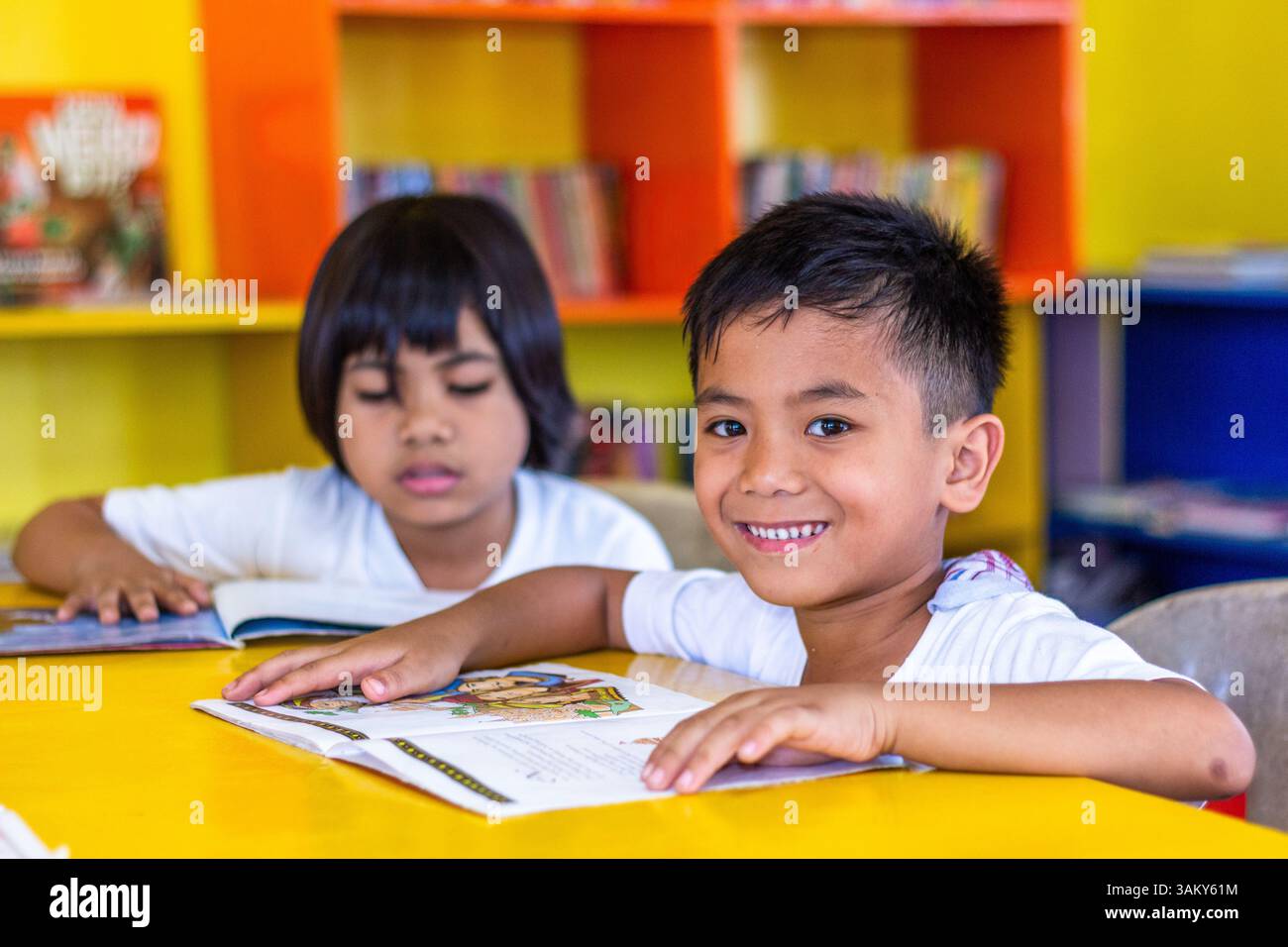 Filipino students enjoy reading time at a public elementary school ...