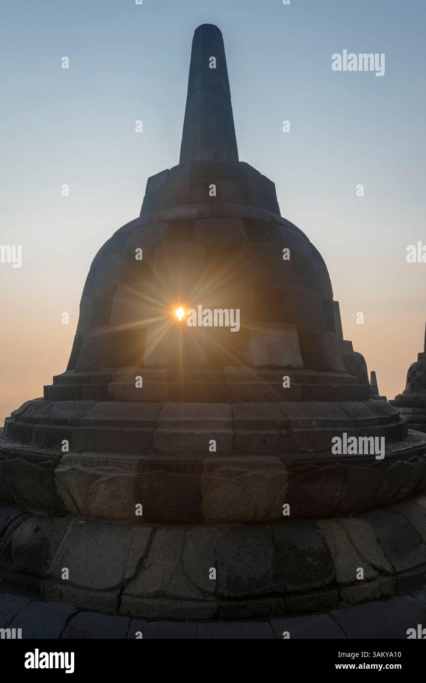 Sunrise through an openwork stupa on Borobudur Temple, Java, Indonesia ...