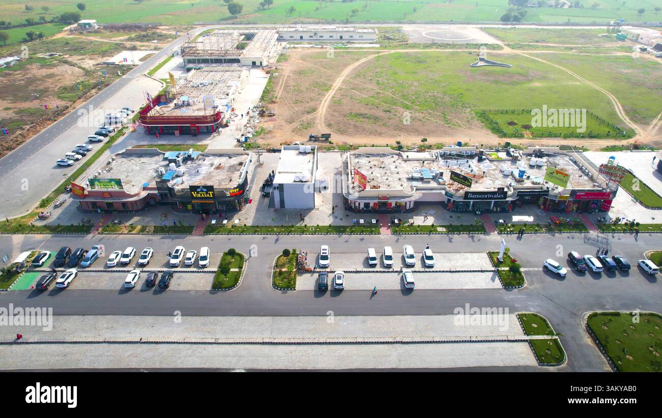 aerial drone shot showing mix of branded food outlets in rest area ...