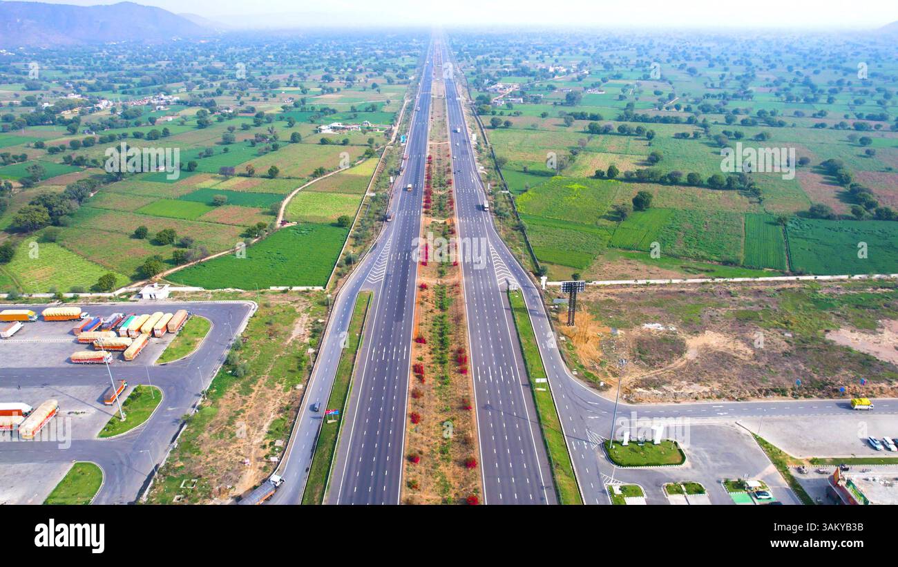 Aerial drone shot locked over eight lane delhi mumbai highway straight ...
