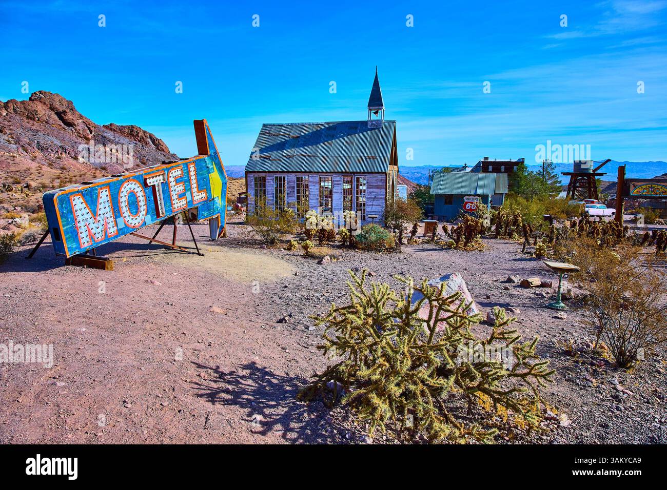 Vintage Motel Sign and Abandoned Church in Desert Landscape Eye Level ...