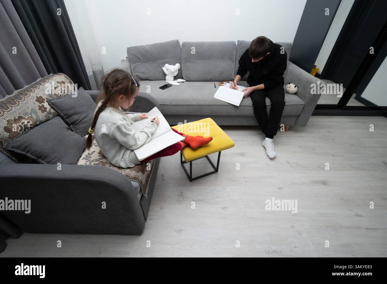 Child and adult engage in artistic activities together, sketching on a ...