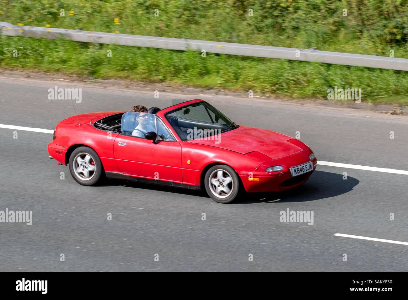 1993 90s nineties Red Eunos Mazda 1590cc roadster travelling on the M6 ...
