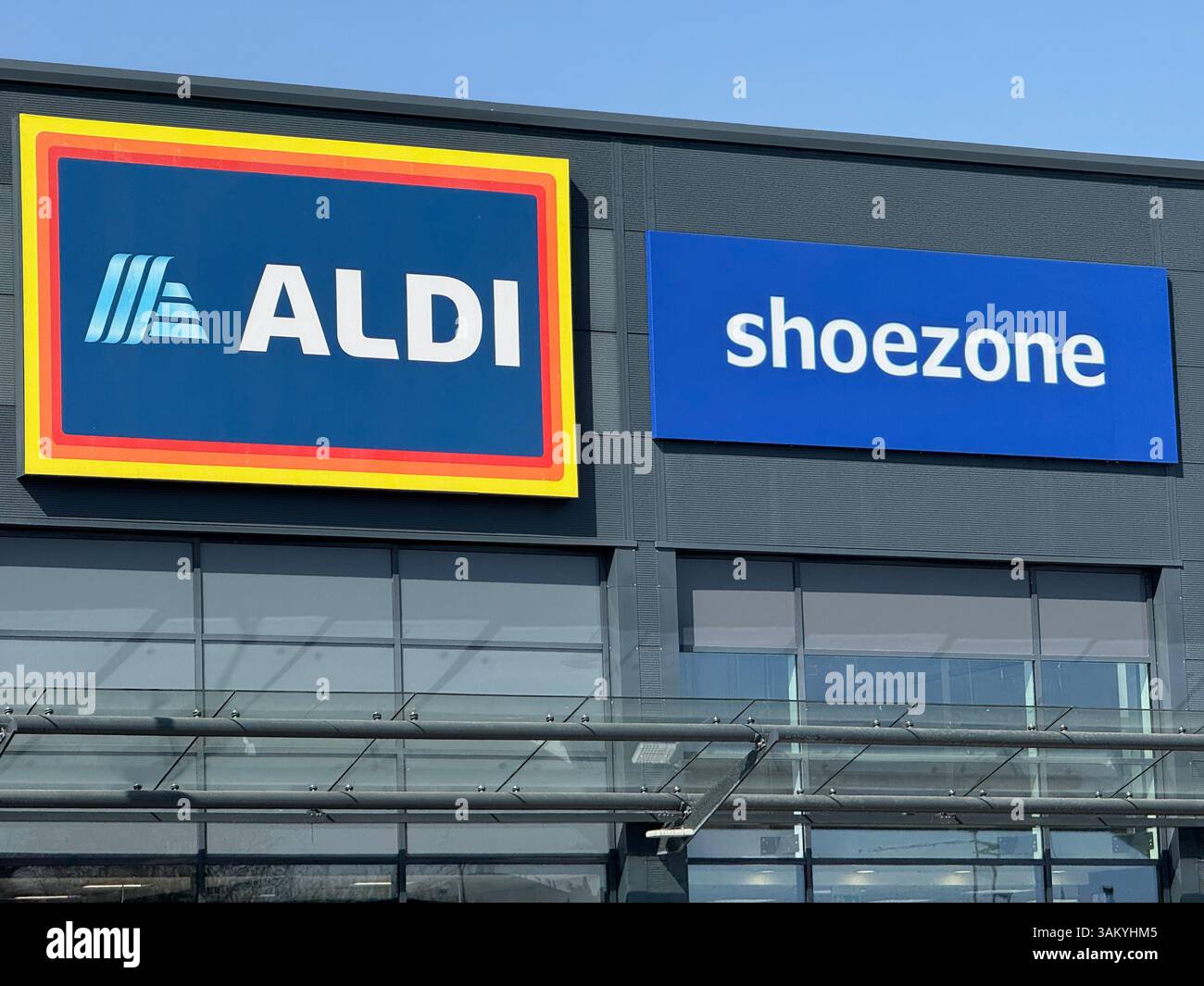 Aldi supermarket, and Shoezone Logos in Burscough UK Stock Photo - Alamy