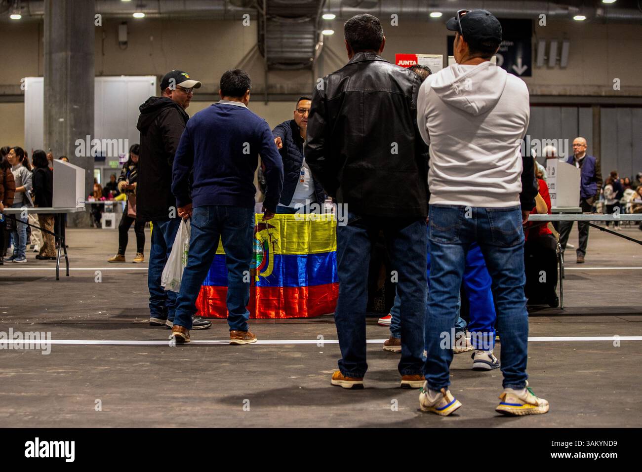 A group of people waits their turn to vote during the voting for ...
