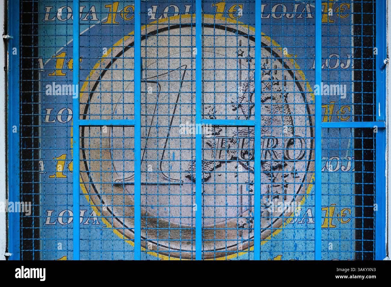 A picture of a one Euro coin decorates the window of a "1 Euro" shop in ...