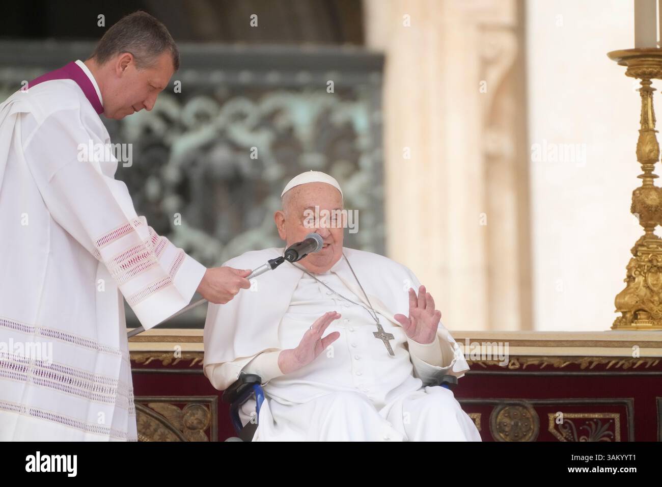 Monsignor Massimiliano Matteo Boiardi, left, holds the microphone for ...