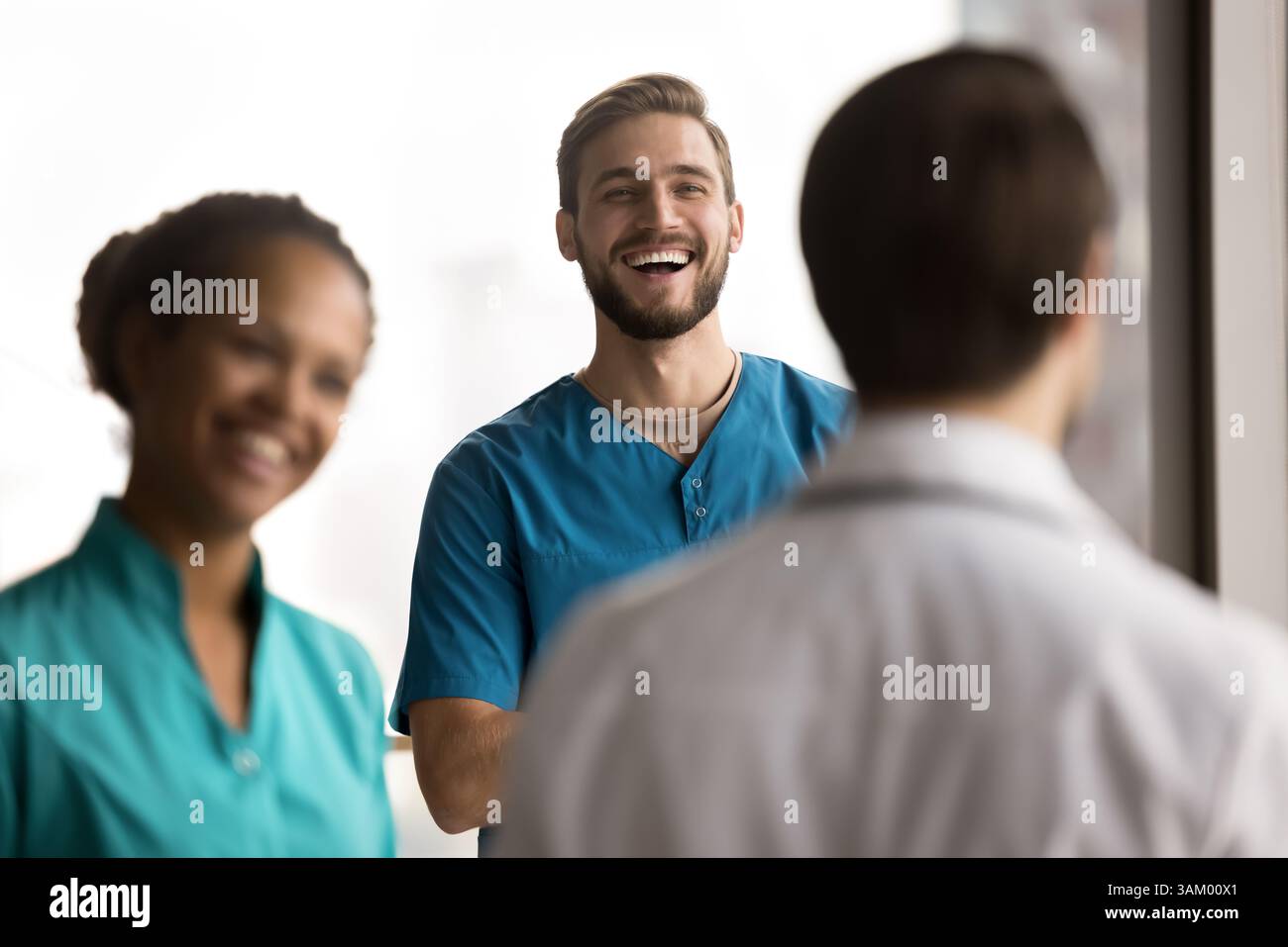 Laughing young man surgeon having fun relax with doctors team Stock ...
