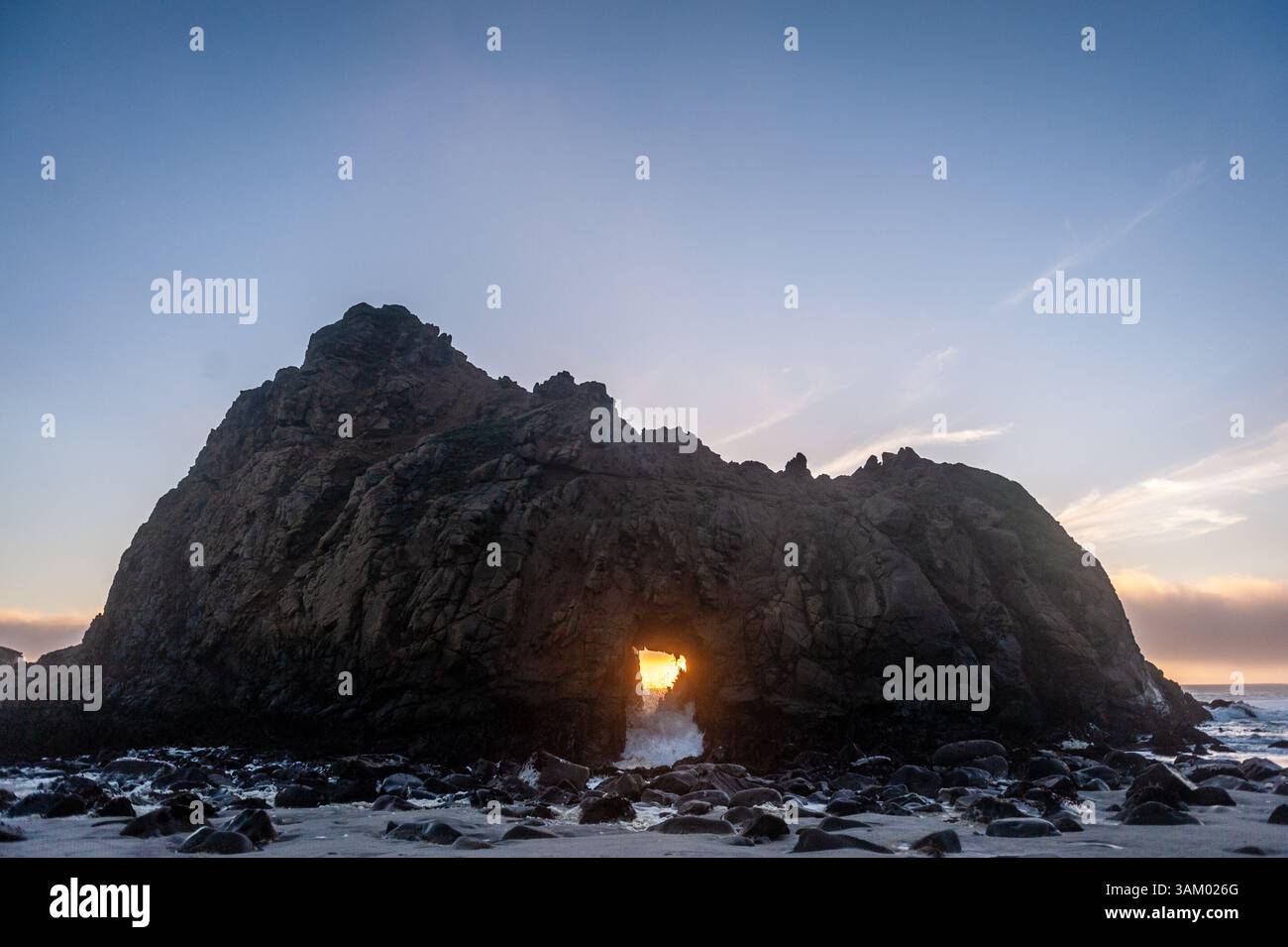 Wide-angle shot of the keyhole arch at Pfeiffer beach, California, whit ...