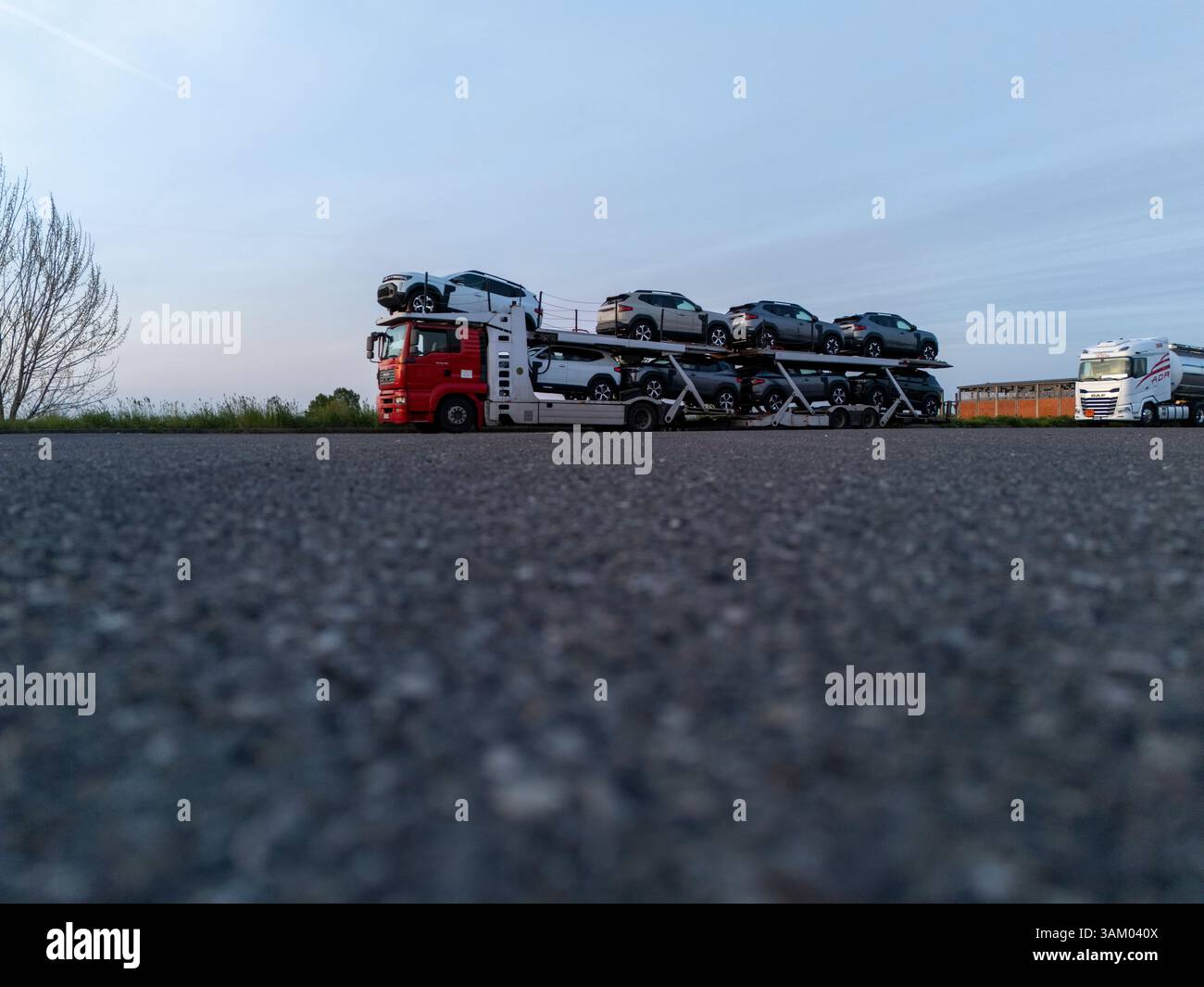 Olza, Italy April 1st 2025 Red car transporter truck carrying new ...