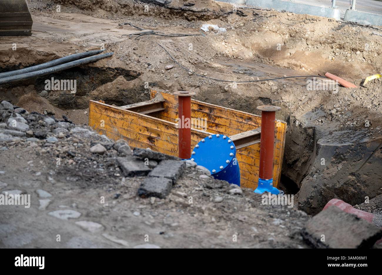 Underground pipeline construction site with trench shoring and blue ...