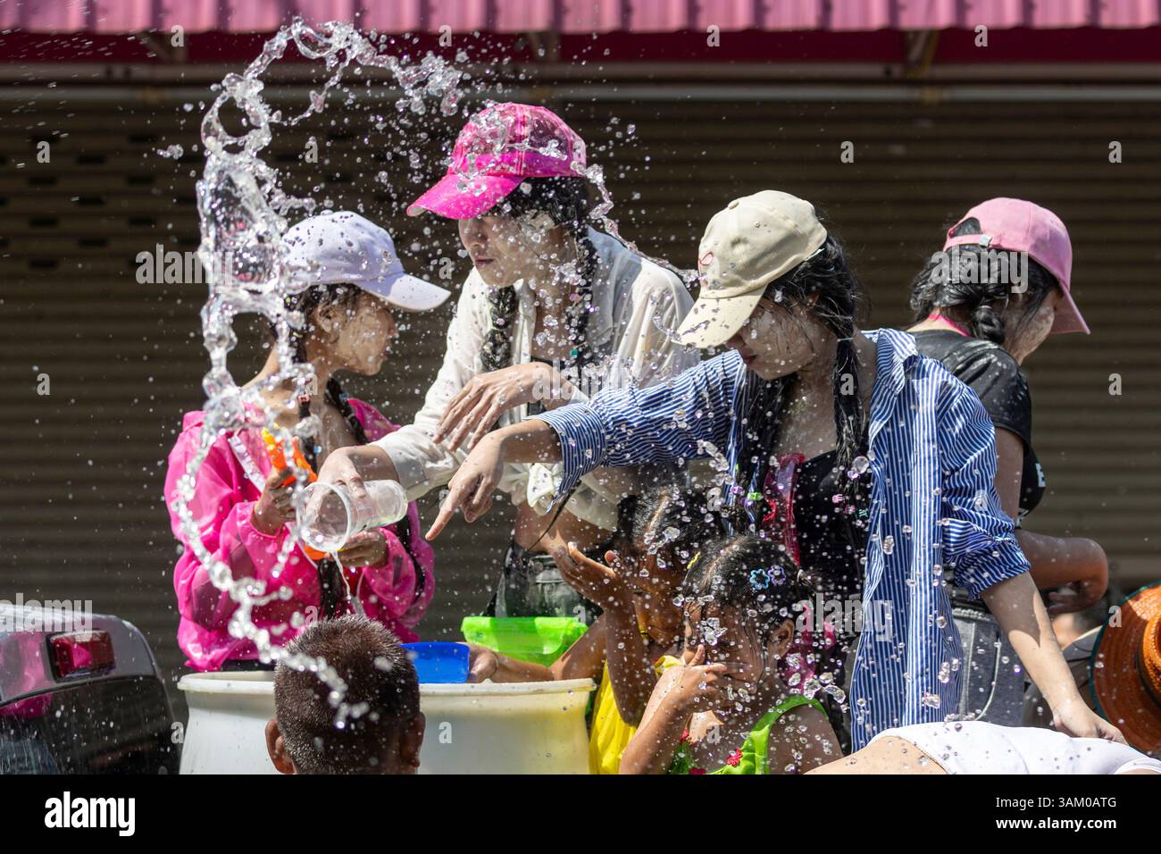 People splash water during the Songkran water festival to celebrate the ...
