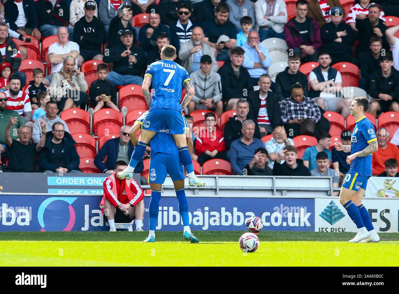 Eco - Power Stadium, Doncaster, England - 12th April 2025 Goalscorer Alistair Smith (bottom) of ...