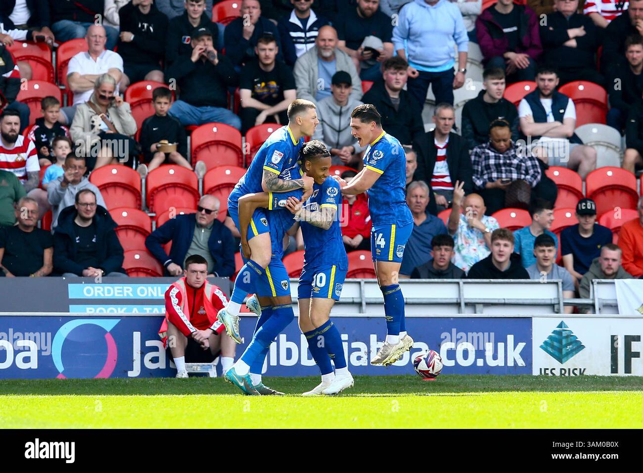 Eco - Power Stadium, Doncaster, England - 12th April 2025 Goalscorer Alistair Smith (2nd left ...