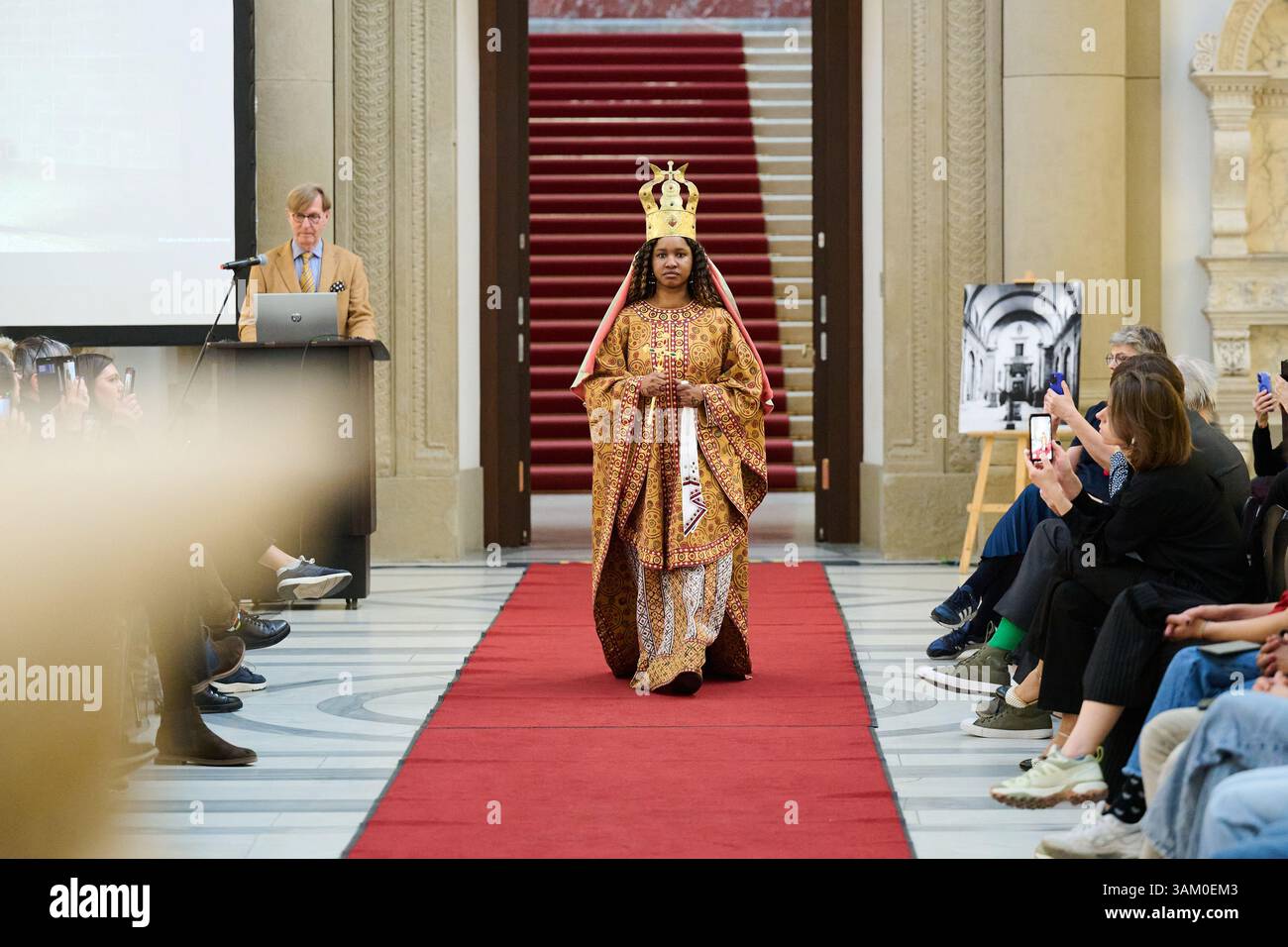 13 April 2025, Berlin: In a fashion show, a model wears a ...