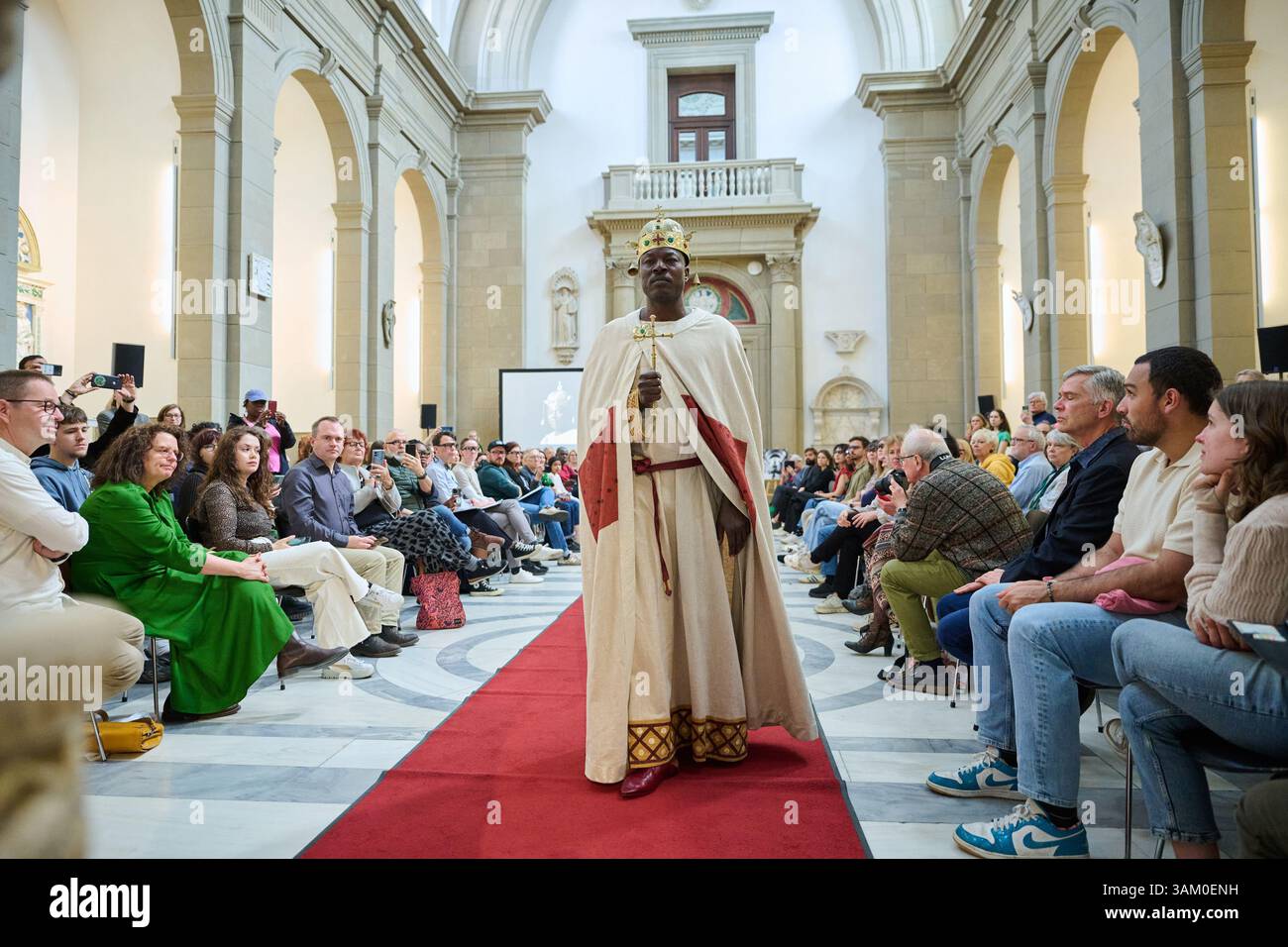 13 April 2025, Berlin: In a fashion show, a model wears a ...