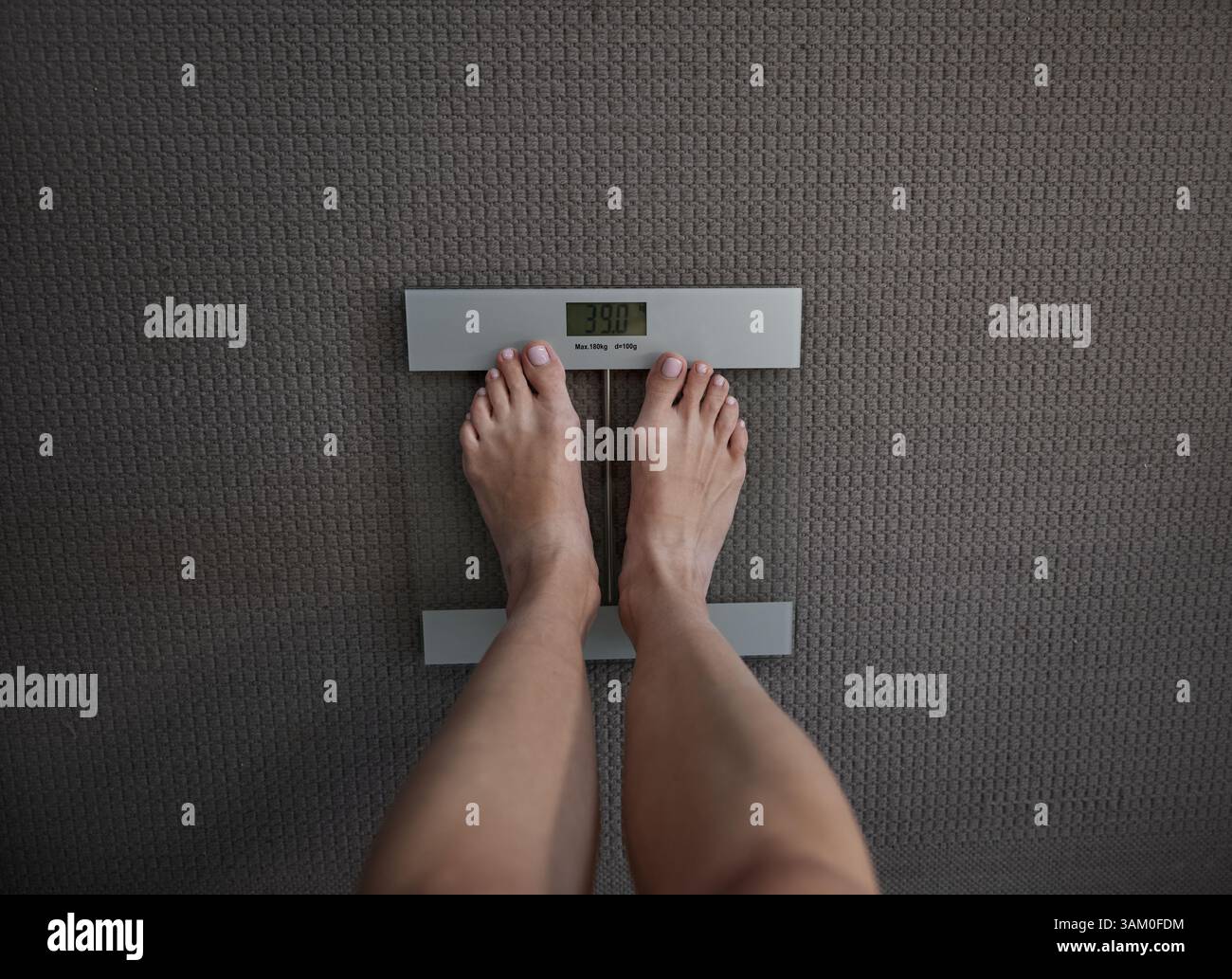View of female feet on scale showcasing anorexic body weight Stock ...