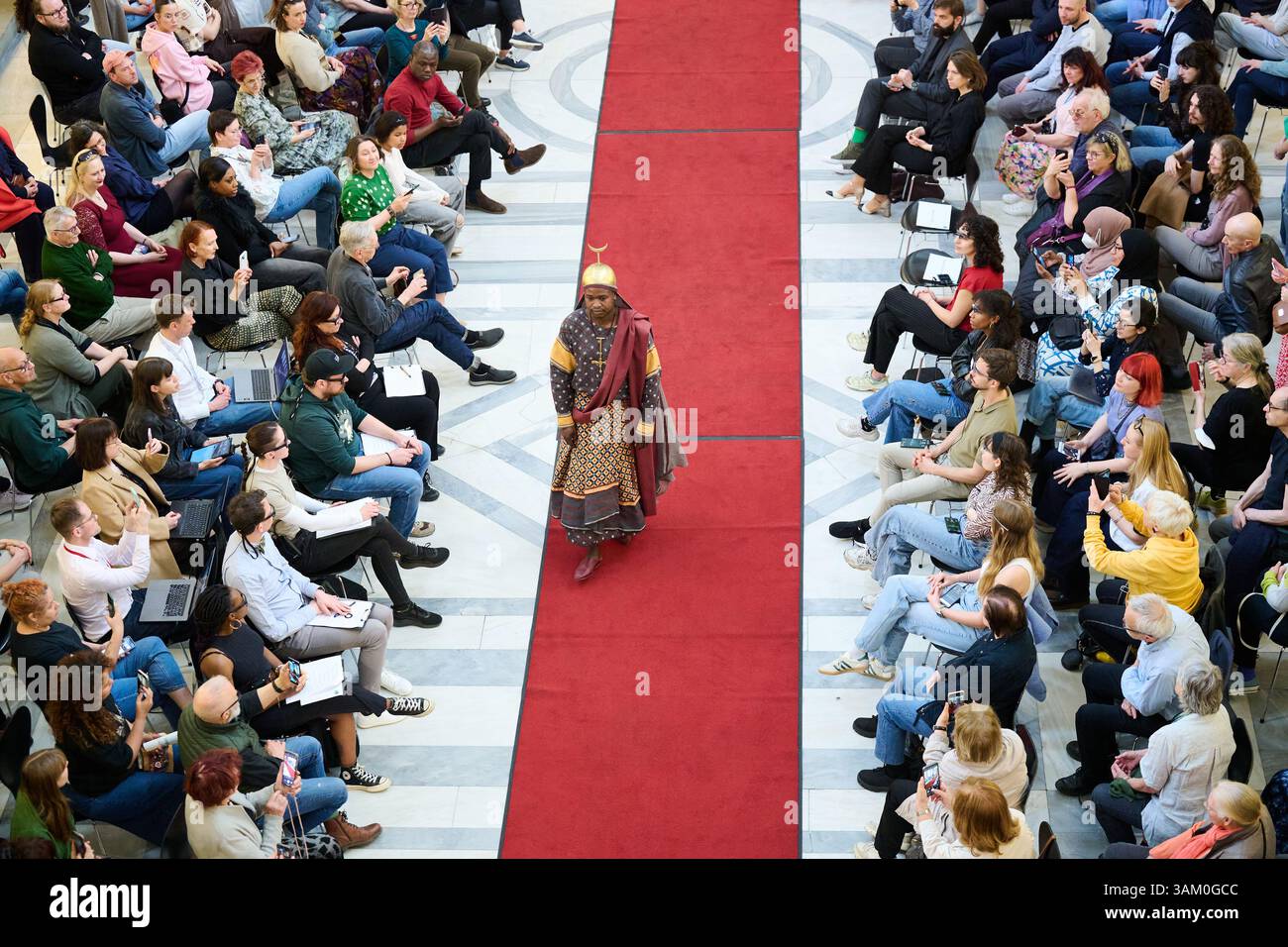 13 April 2025, Berlin: In a fashion show, a model wears a ...