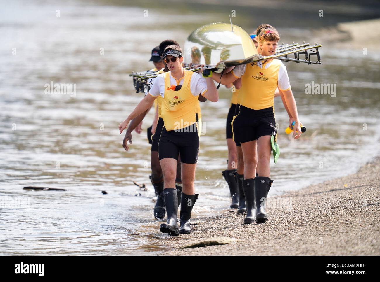 The Cambridge reserve crew with Goldie head to the water on the River ...