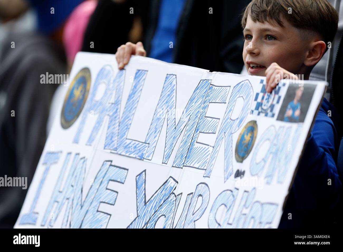 A Young Cheslea Fan Holding A Sign In The Stands Before The Premier A Young Cheslea Fan Holding A Sign In The Stands Before The Premier