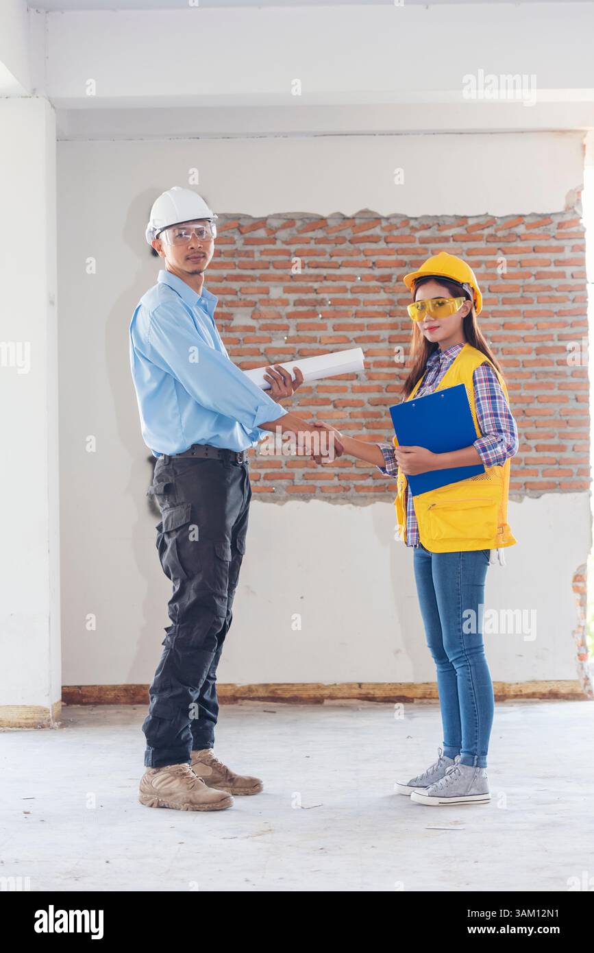 Civil Construction engineer teams shaking hands together wear work ...