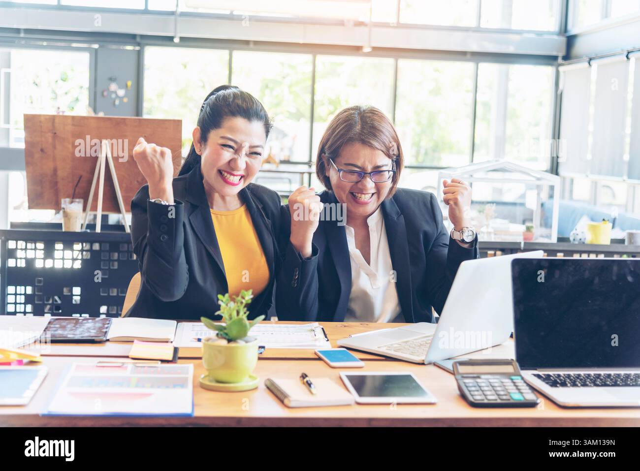 Happy success business woman partner working together in company office ...