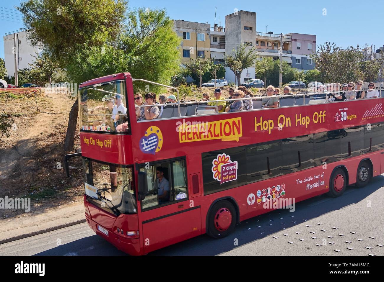 Crete.Greece - april 13, 2025: A bright red open-top tourist bus ...