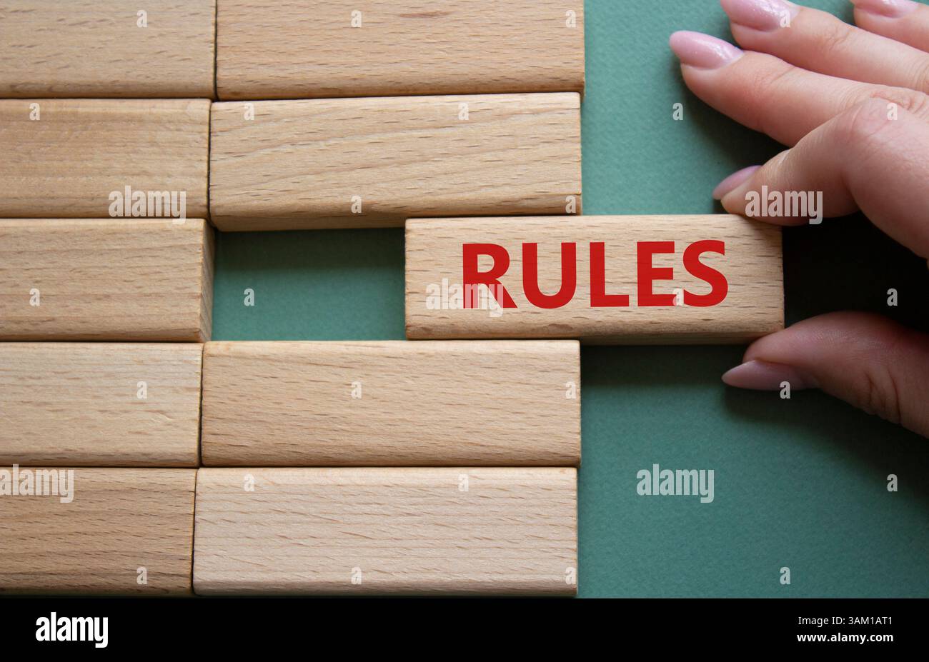 Rules symbol. Wooden blocks with word Rules. Businessman hand ...