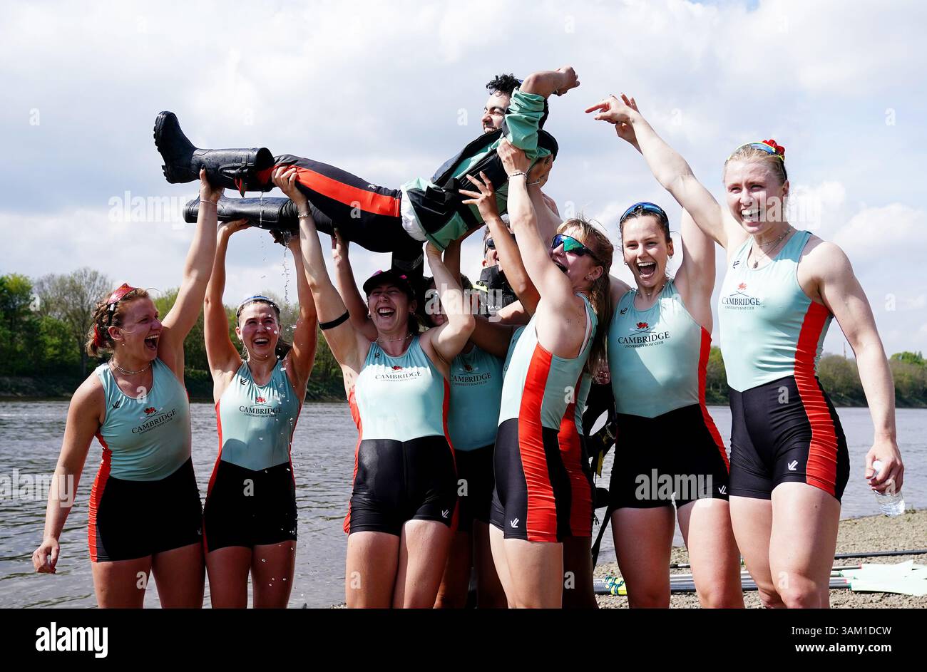 The Cambridge Women's team lift cox Jack Nicholas after winning The 79th CHANEL J12 Women's Boat ...