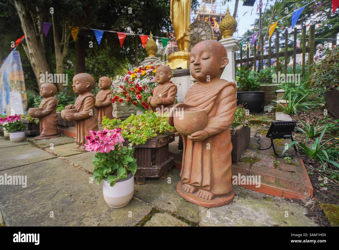 London UK 13 April 2025. Small buddha statues at the Thai New Year ...