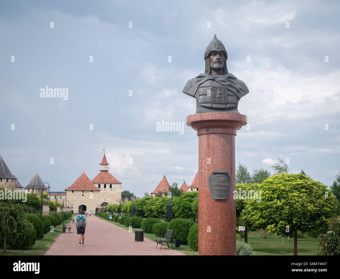 Historical statue of medieval warlord with historical fortress in ...